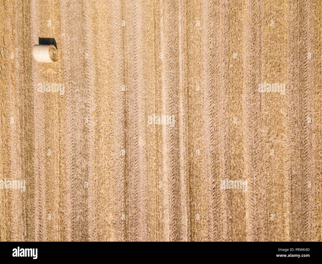 Aerial view of one round hay bale on stubble, view from directly above ...
