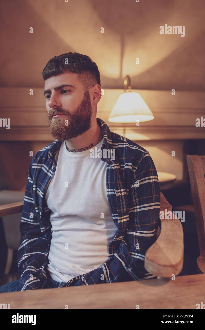Portrait handsome bearded man wearing plaid shirt at modern cafe Stock ...