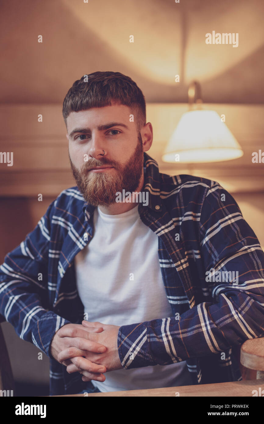 Portrait handsome bearded man wearing plaid shirt at modern cafe Stock ...