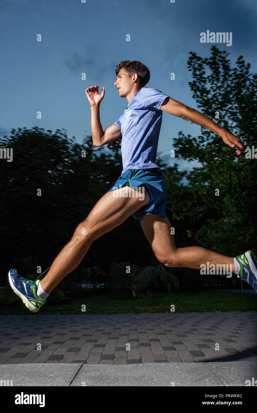 Man running in the city park at the sunset Stock Photo - Alamy
