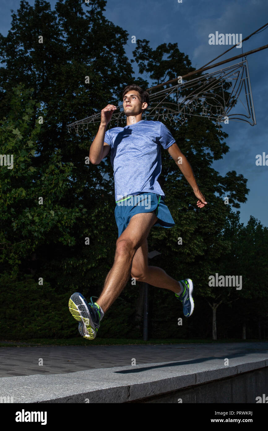Man running in the city park at the sunset Stock Photo - Alamy
