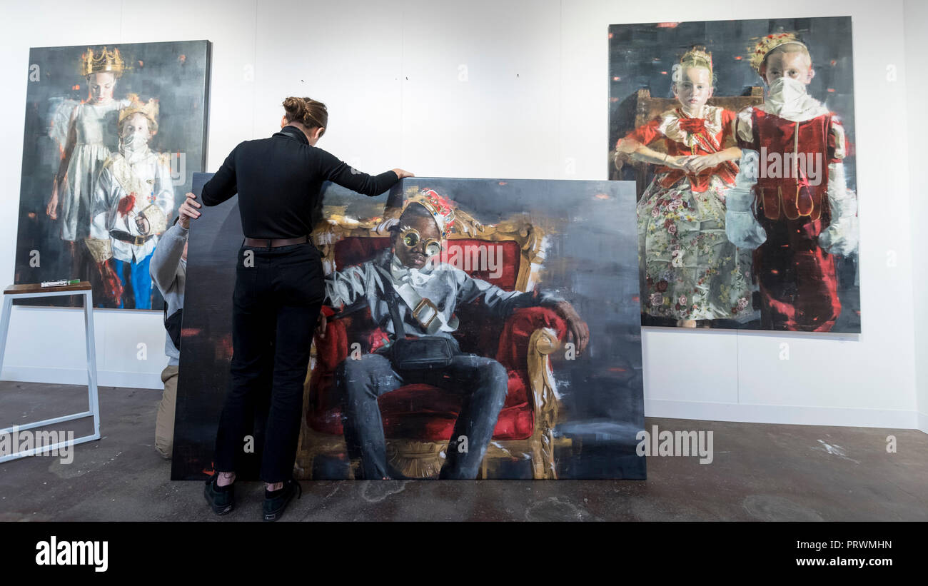 London, UK. 4 October 2018. Staff prepare to hang paintings by Kaili ...