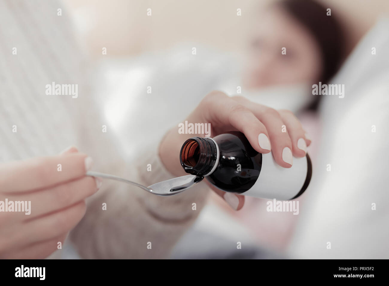 Close up of cough syrup being poured in spoon Stock Photo - Alamy