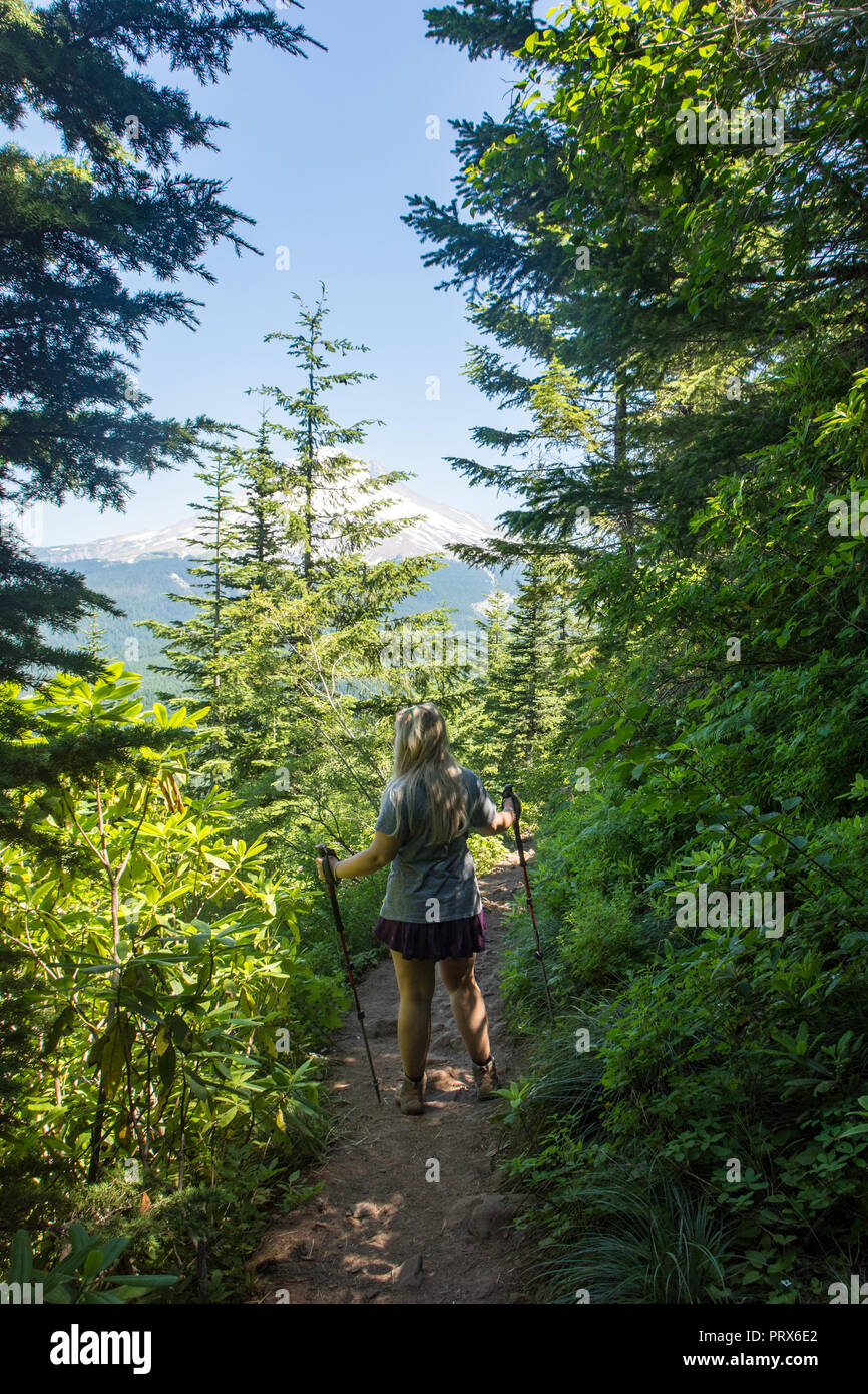 A blonde female hiker makes her way through the forest on the Mirror ...