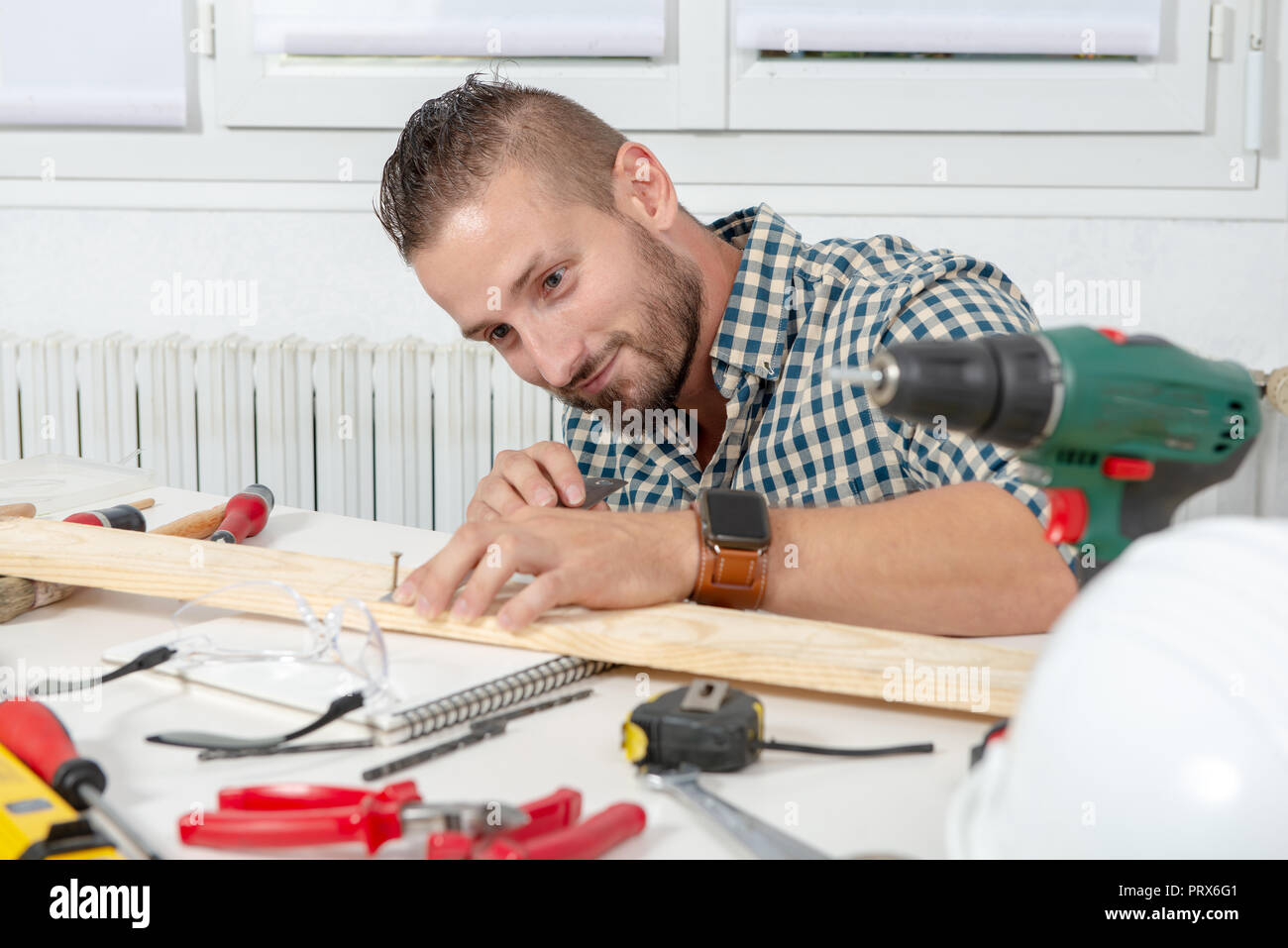 a smiling young man DIY at home Stock Photo - Alamy