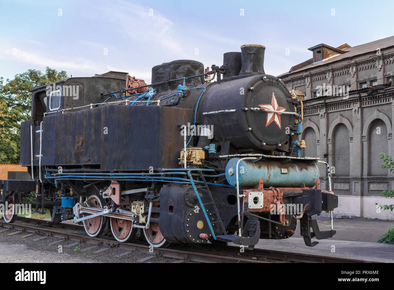 Old rusty steam locomotive standing on the rails Stock Photo - Alamy