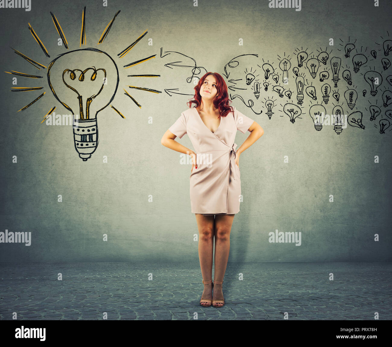 Full length portrait of a redhead young woman standing with hands on ...