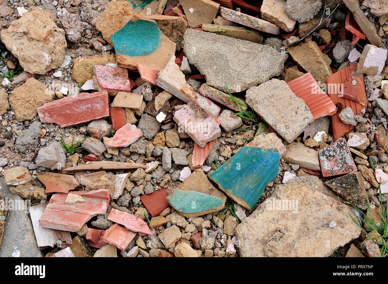 demolition waste on floor with gravel, broken bricks and rooftiles with ...
