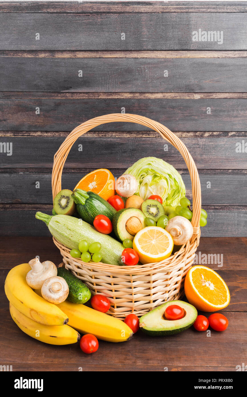 Natural organic colorful fruits and vegetables over grey and brown ...