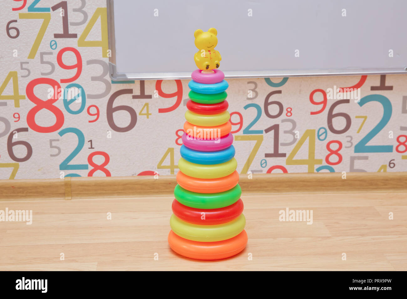 Pyramid build from colored wooden rings with a clown head on top. Toy ...