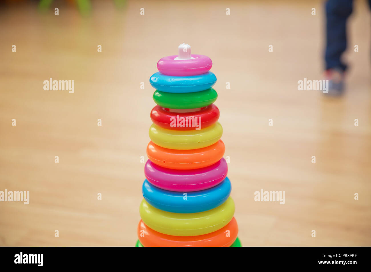 Pyramid build from colored wooden rings with a clown head on top. Toy ...