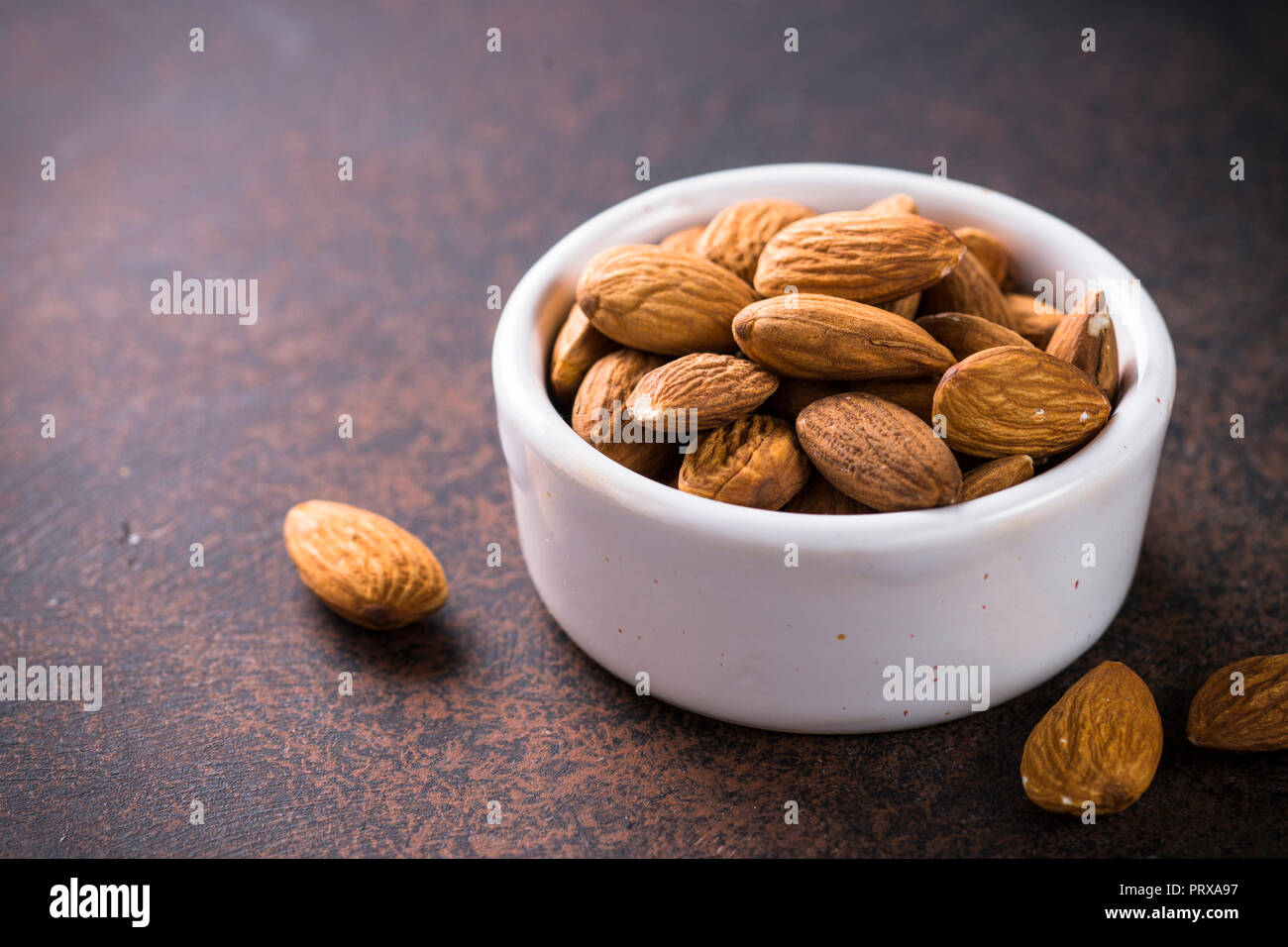 Almonds nuts in wooden bowl Stock Photo - Alamy