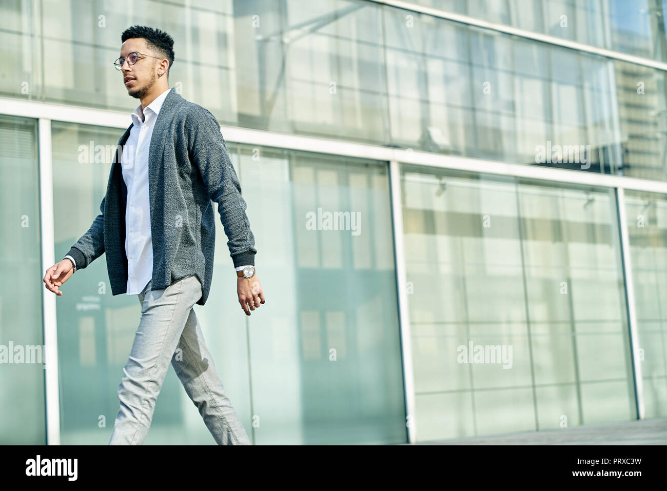Businessman walking outside office Stock Photo - Alamy