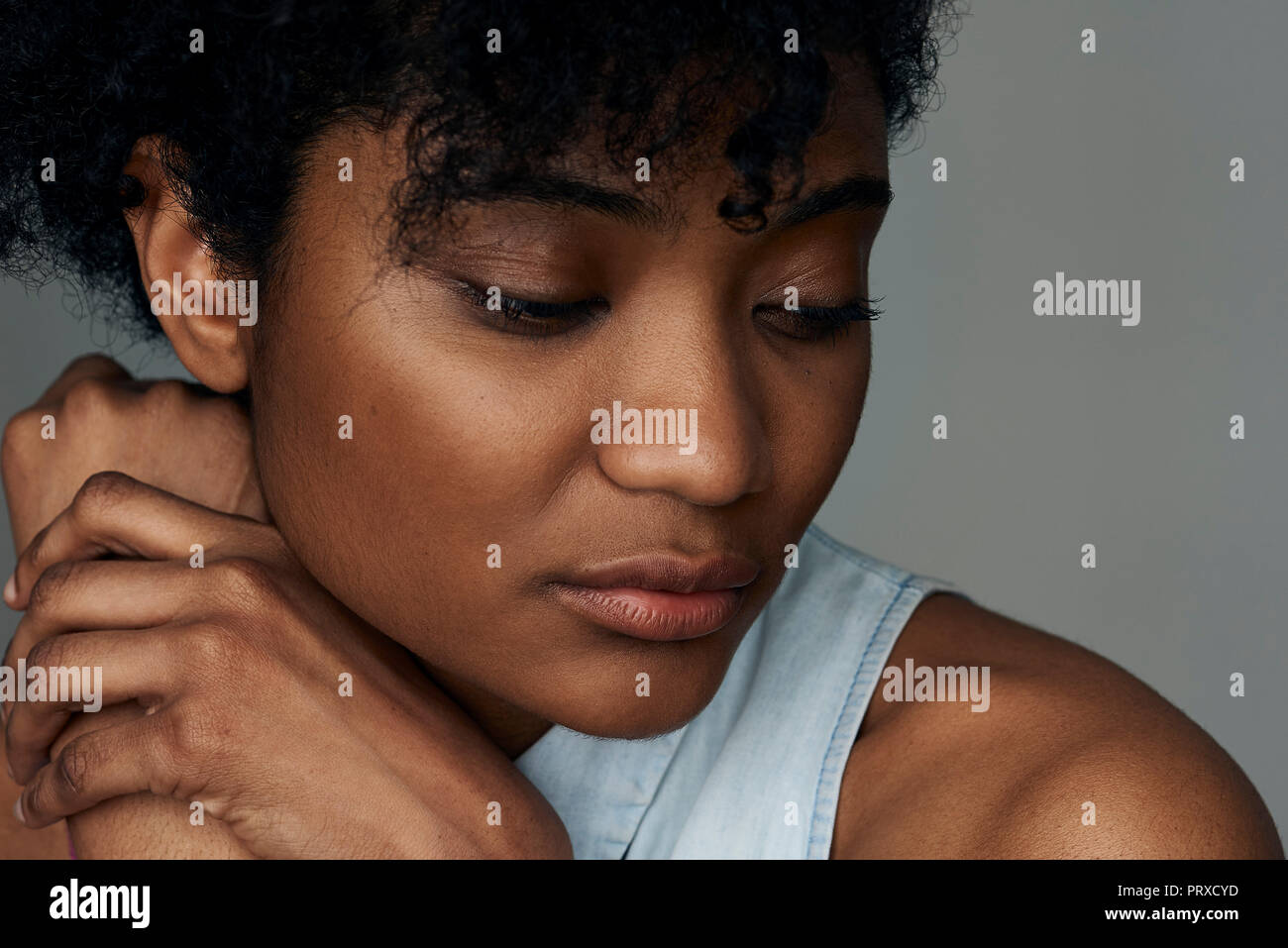 Sad woman touching hair hi-res stock photography and images - Alamy