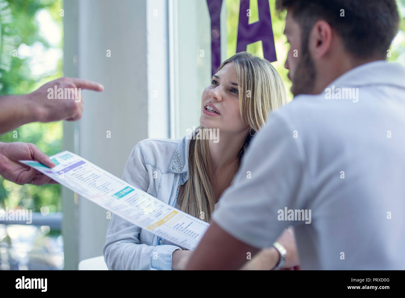 Waitress helping customer Stock Photo - Alamy