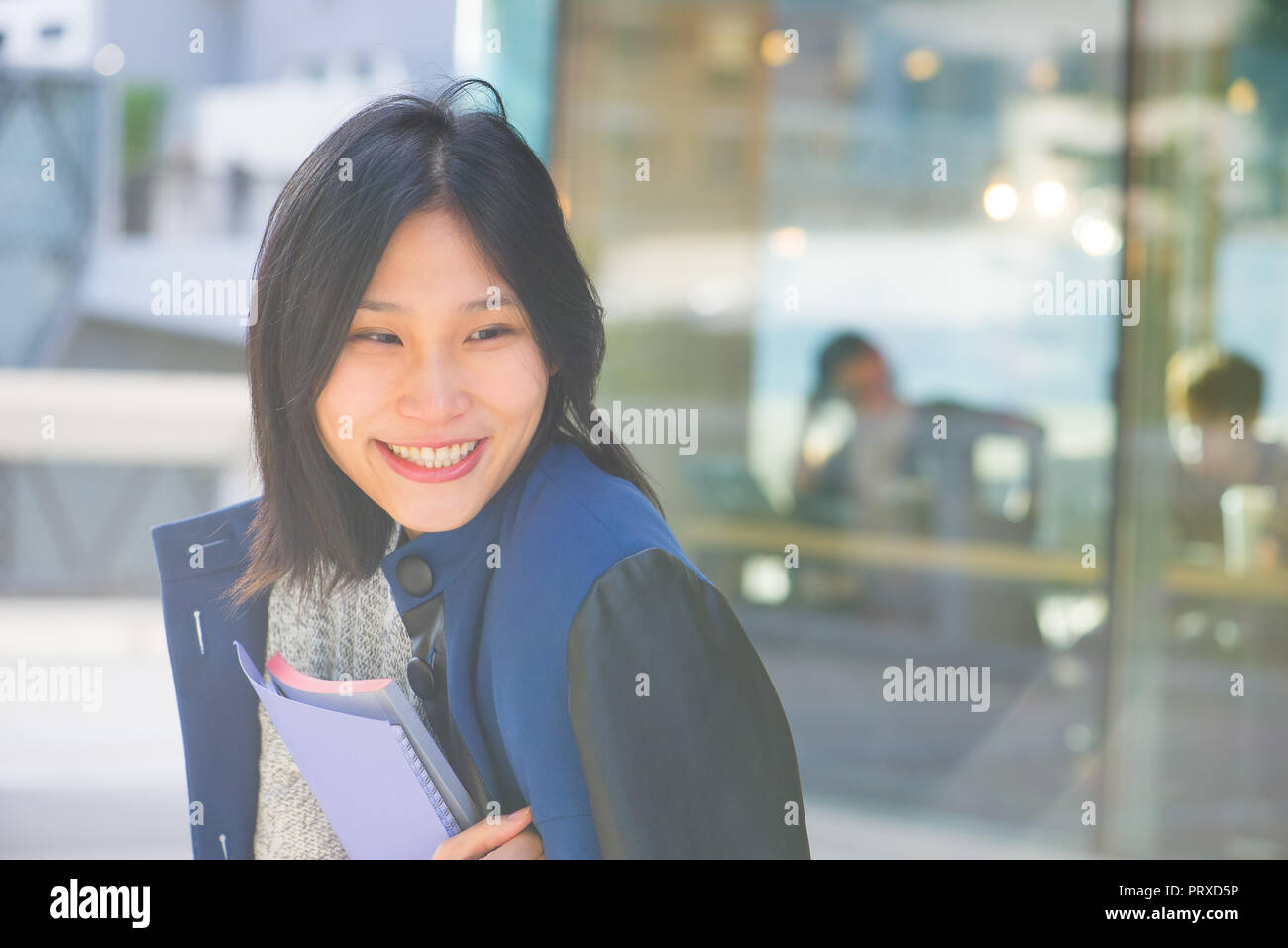 Woman holding laptop and file Stock Photo - Alamy