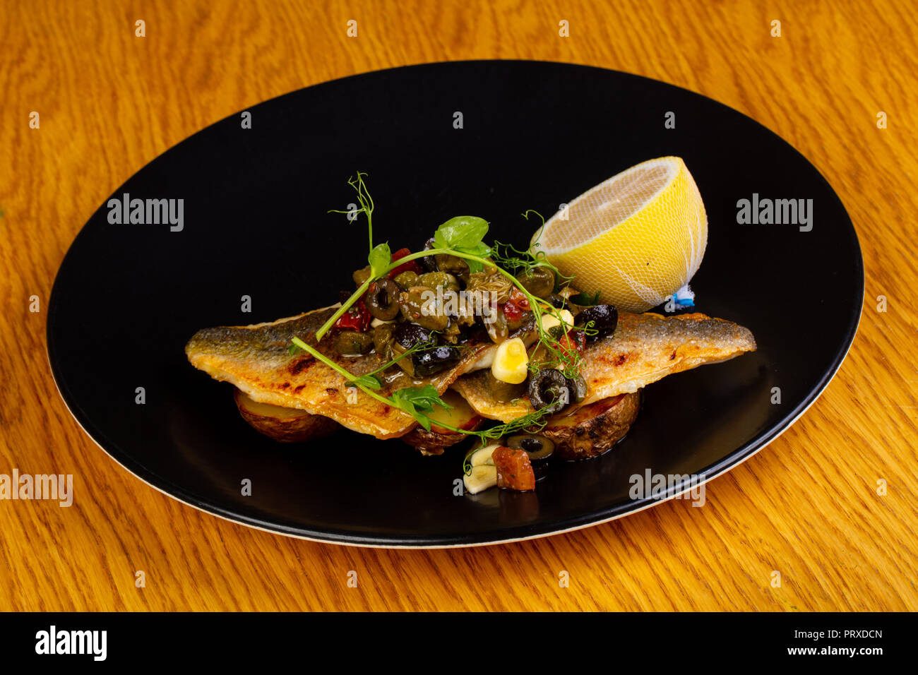 Dorada fillet with herbs and lemon Stock Photo - Alamy