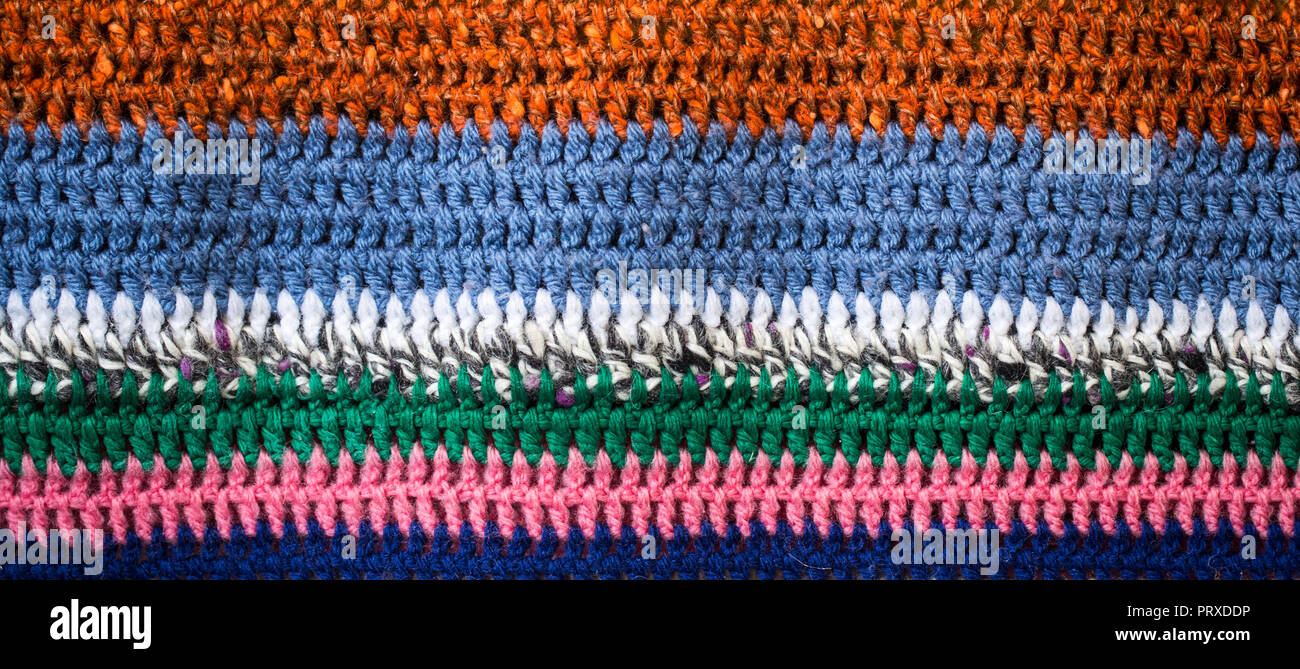 multi-colored knitted cosy texture closeup background,the concept of ...