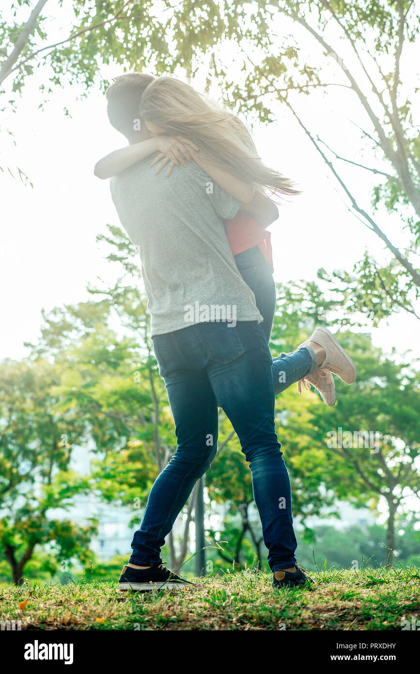 Couple hugging in park Stock Photo - Alamy