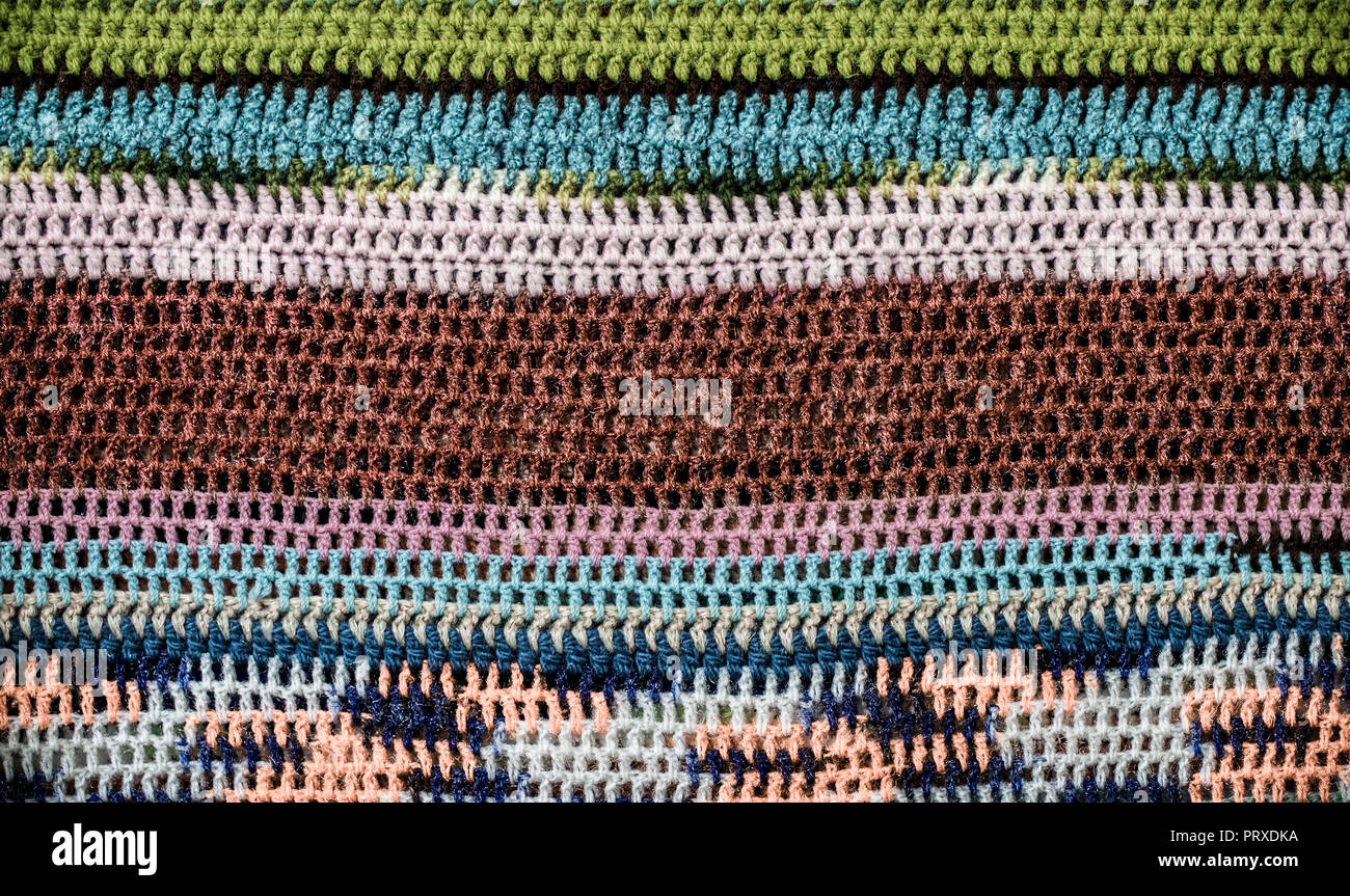 multi-colored knitted cosy texture closeup background,the concept of ...