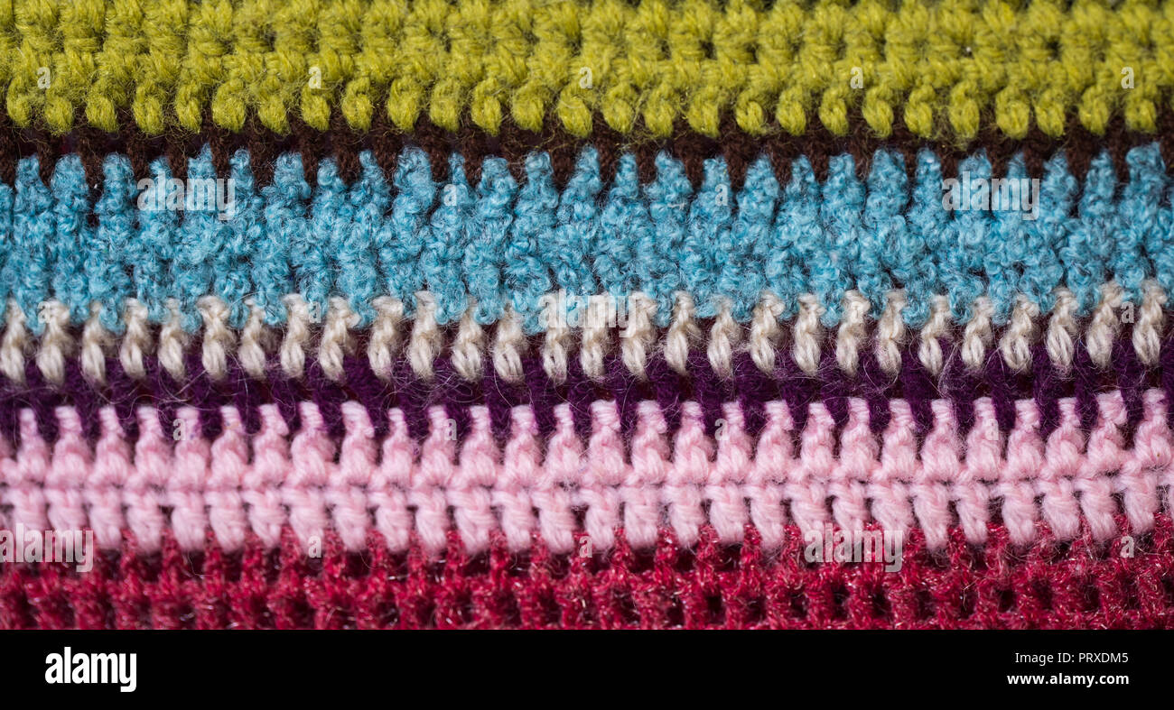 multi-colored knitted cosy texture closeup background,the concept of ...