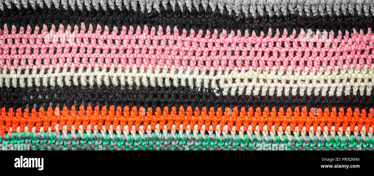multi-colored knitted cosy texture closeup background,the concept of ...