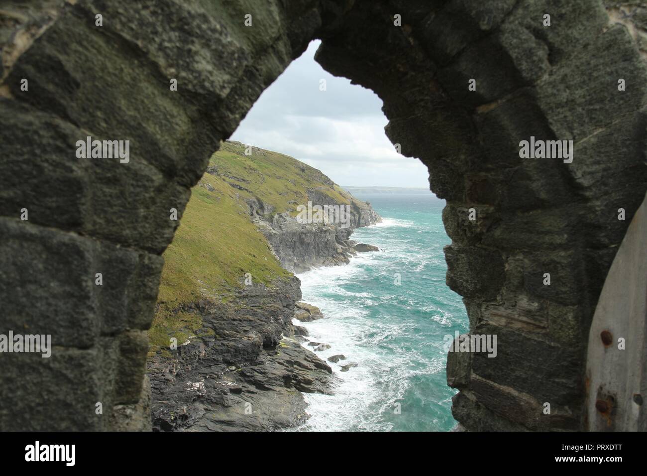 June 2015 - view of dramatic Cornwall coastline through a stone ...