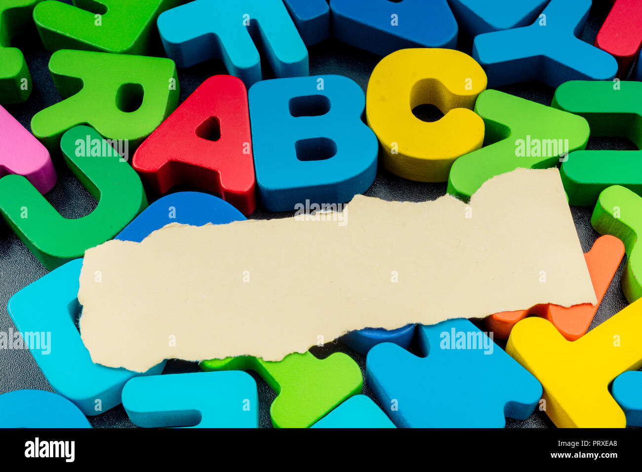 Torn paper placed on Colorful Letters of Alphabet Stock Photo - Alamy