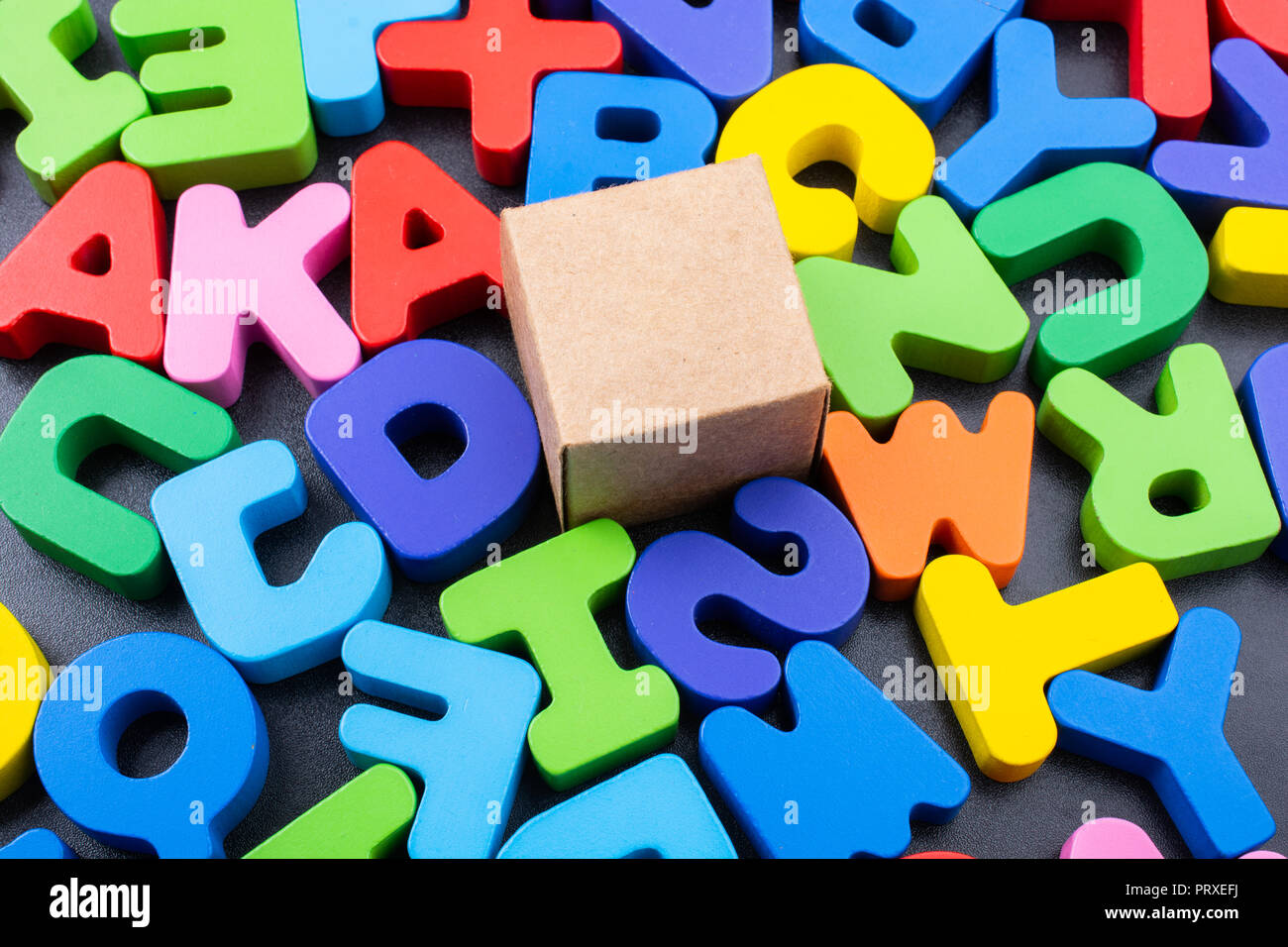 Cardboard box cube and Colorful Letters of Alphabet Stock Photo - Alamy