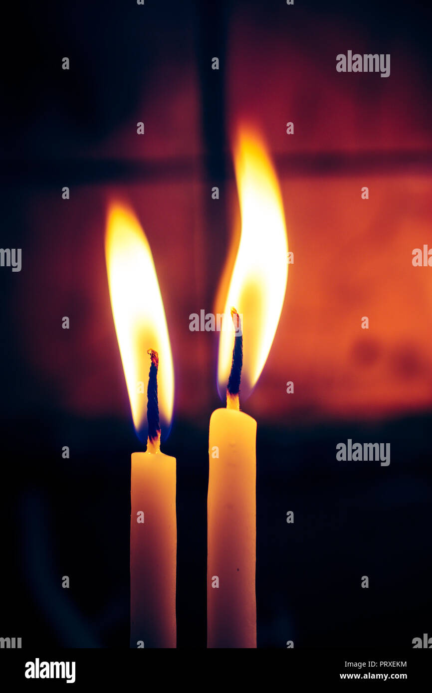 Candles burning in the dark with flame Stock Photo - Alamy