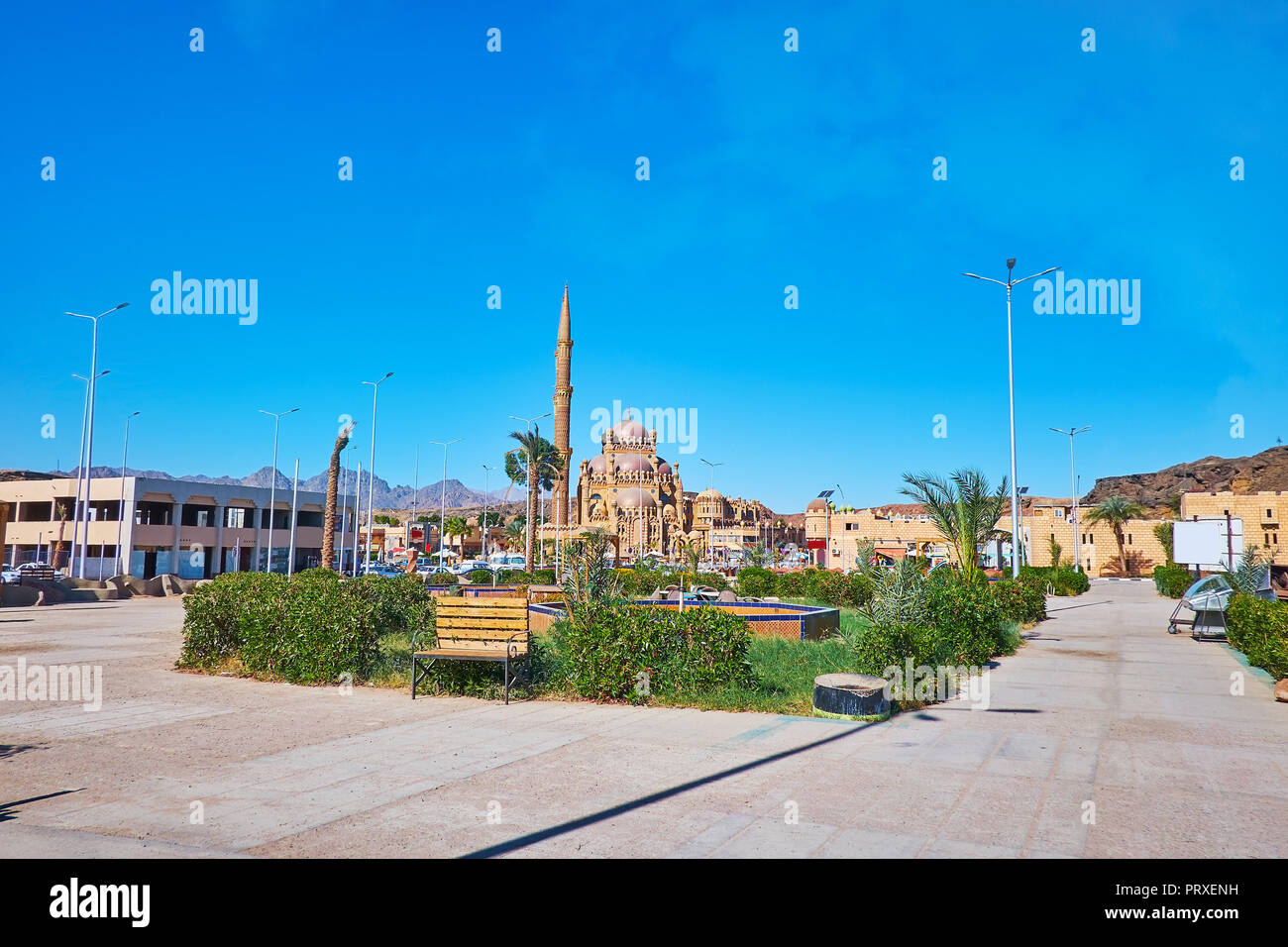 The tiny park in Sharm El Maya district with a view on tall Al Mustafa ...
