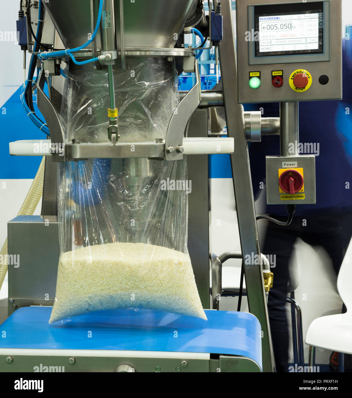Rice fill into plastic by packing machine ; close up Stock Photo - Alamy