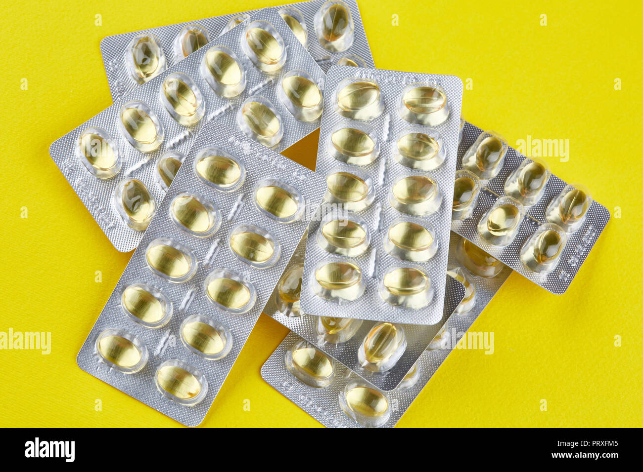 Sealed packages with transparent capsules on yellow background ...