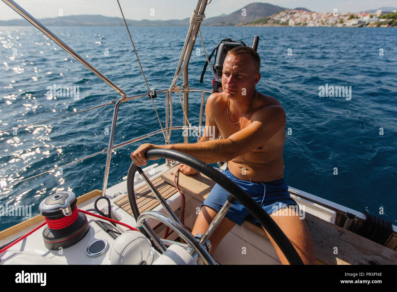 Man skipper runs a sailing yacht on the Sea Stock Photo - Alamy