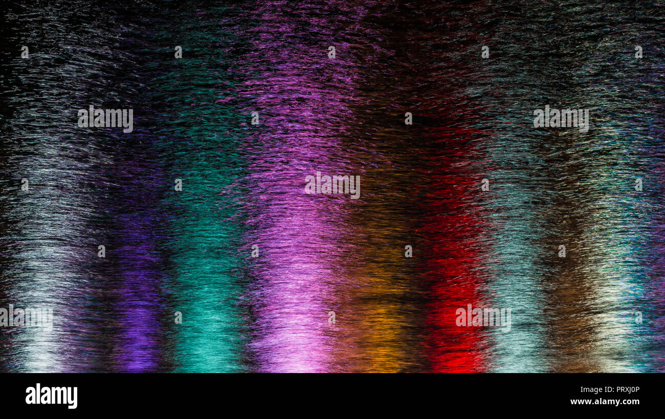 The reflection of the multicolor light on the water surface Stock Photo ...