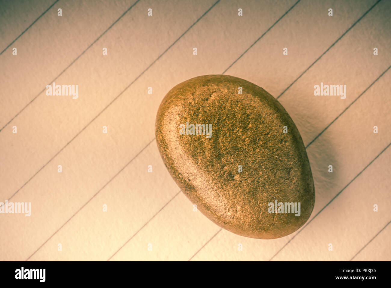 Little gold color stone on with a background Stock Photo - Alamy