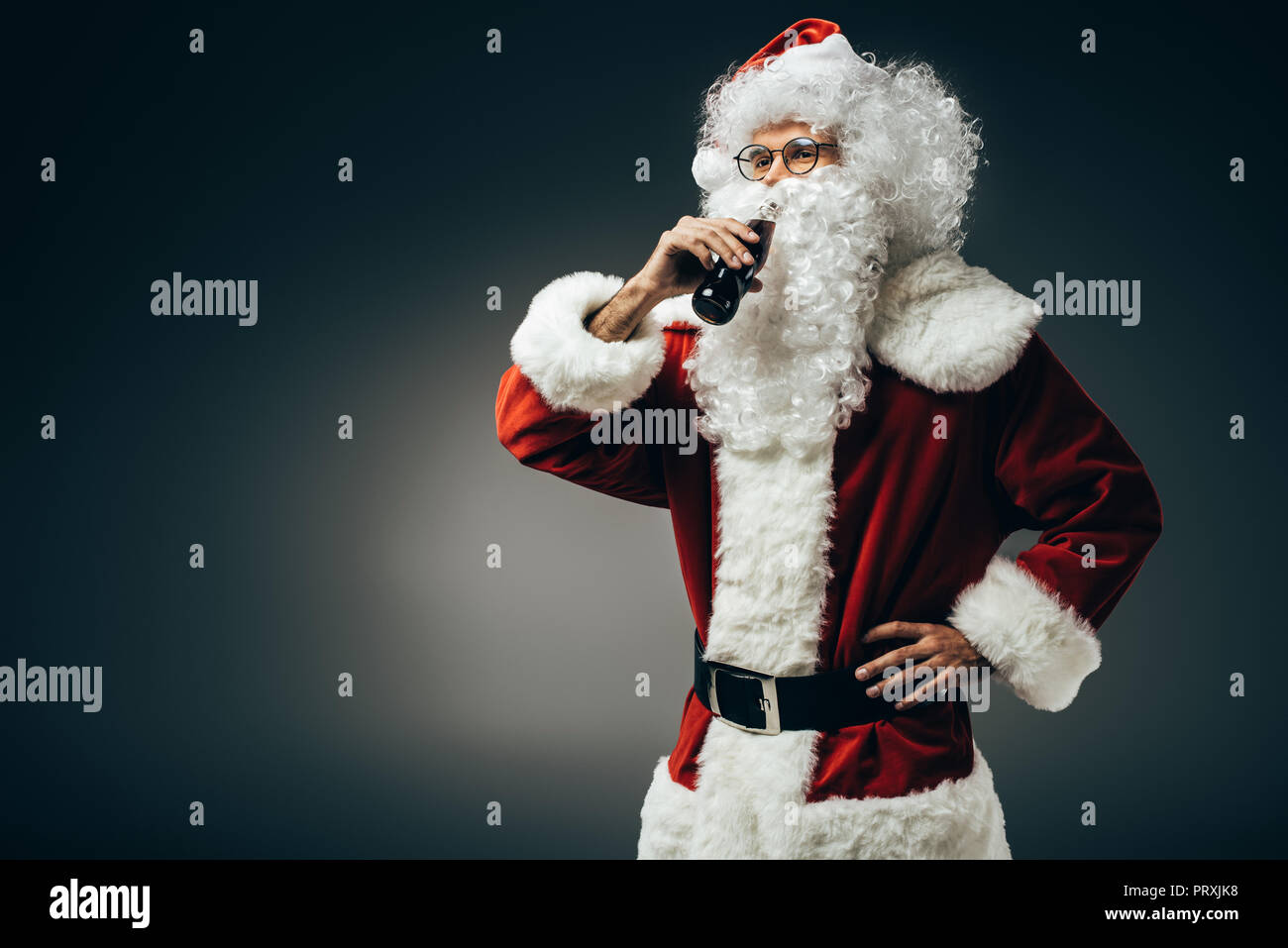 santa claus in costume drinking cream soda isolated on grey background ...