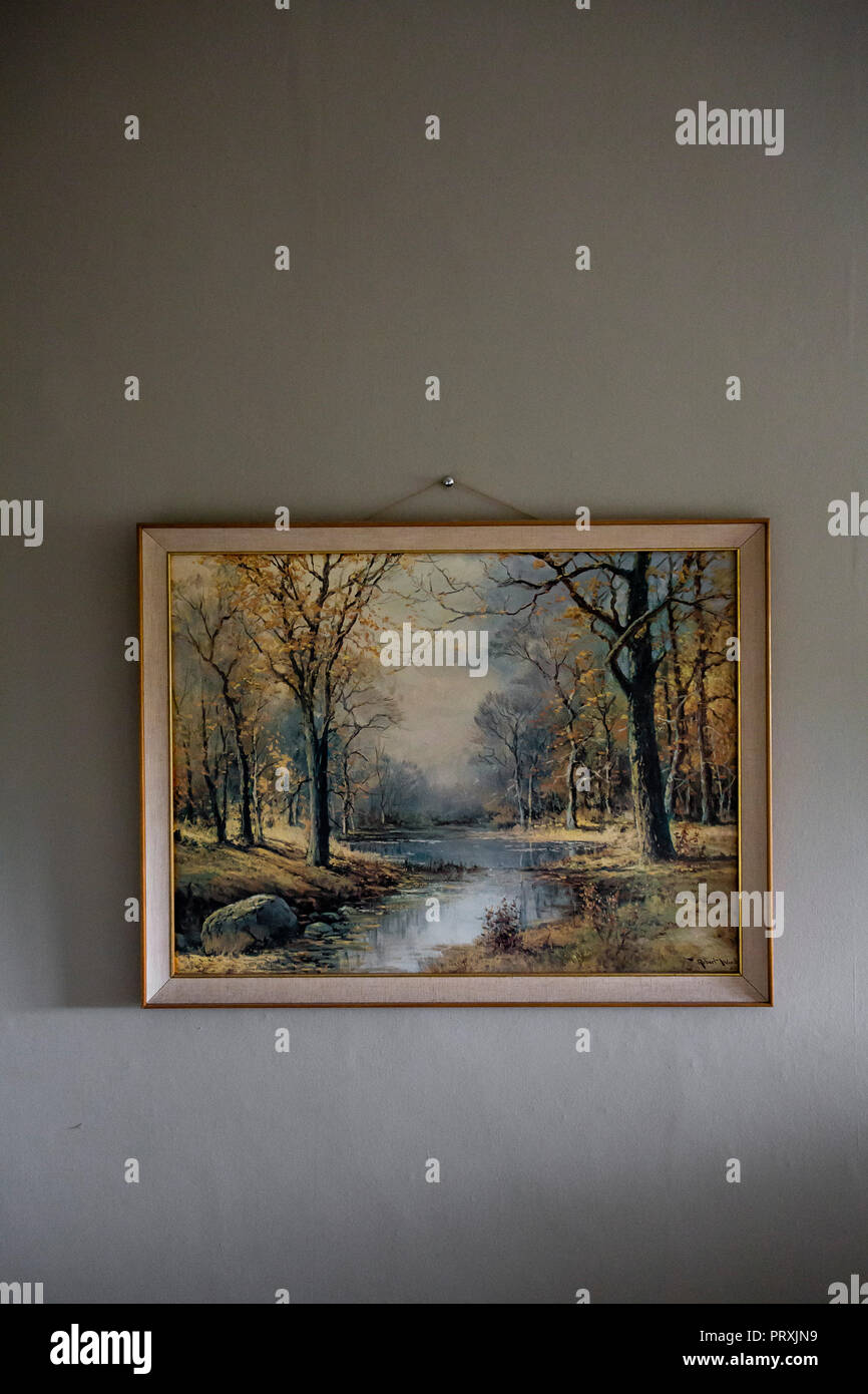 A painting of a forest scene hanging on the wall of a house Stock Photo ...