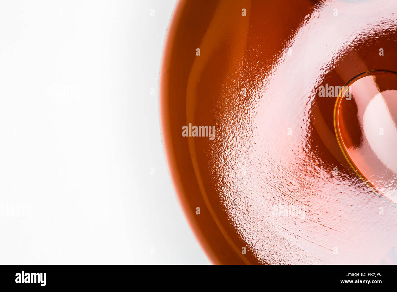 A bottle of amber coloured alcohol, whisky with a trapped bubble under ...