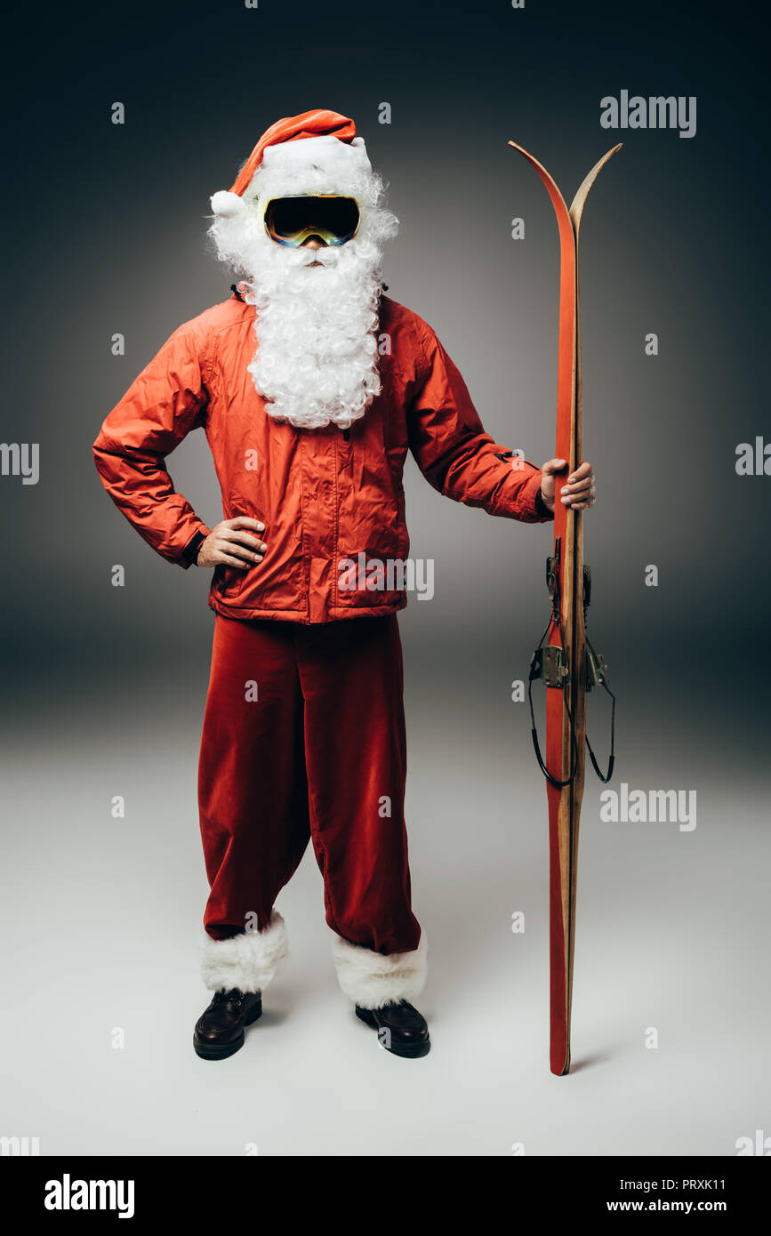 serious santa claus in ski mask and windbreaker standing with hand on ...