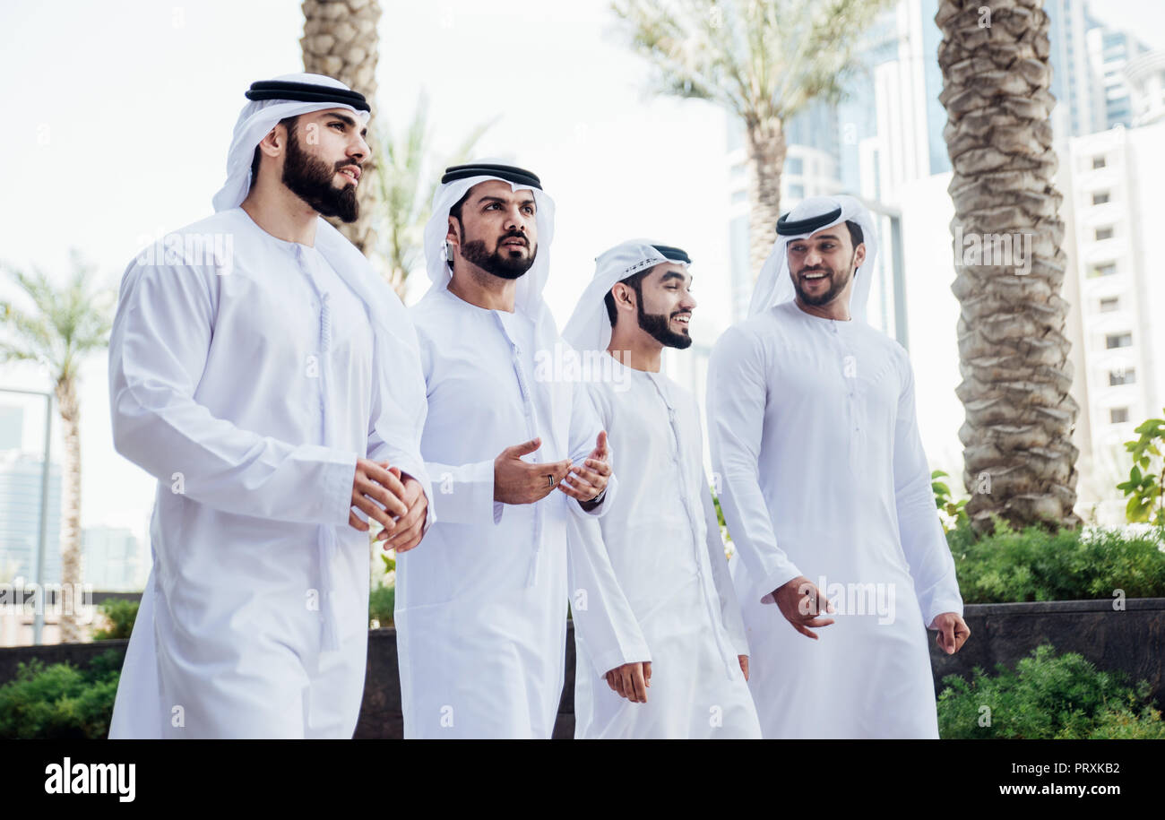 Group of businessmen talking on the street in Dubai Stock Photo - Alamy