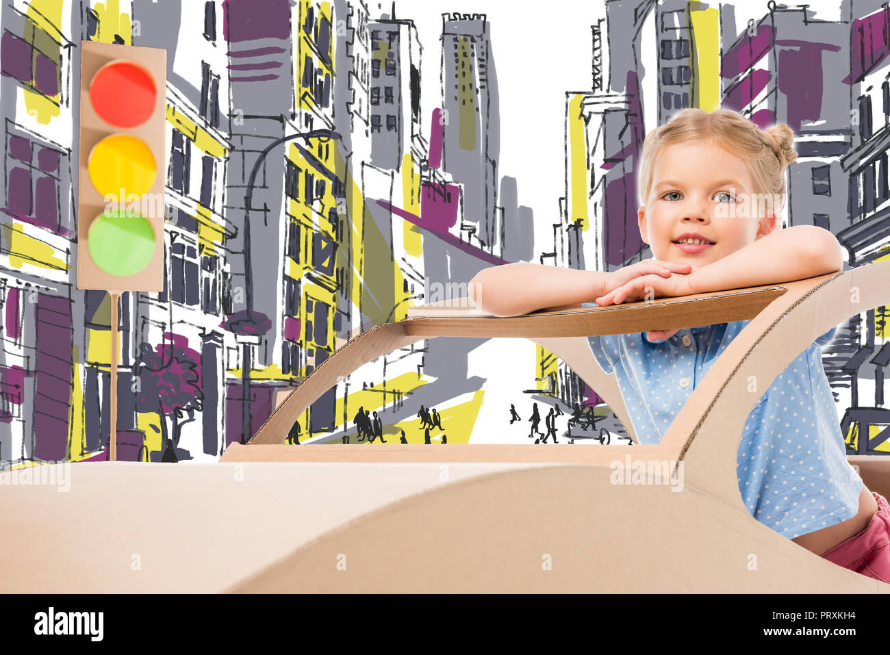 adorable child playing with cardboard car and traffic lights on street ...