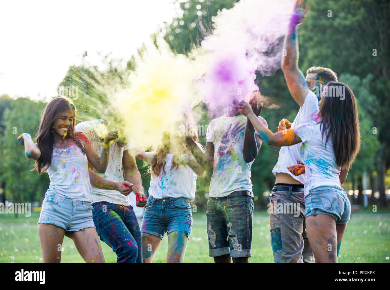 Group of teens playing with colors at the holi festival, in a park Stock Photo - Alamy