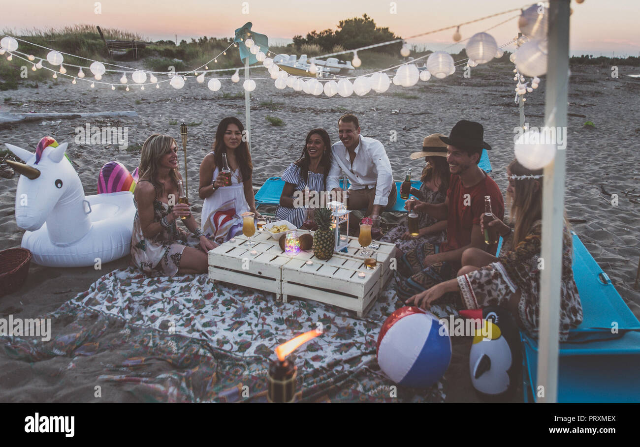 Group of friends making party on the beach at sunset time Stock Photo ...