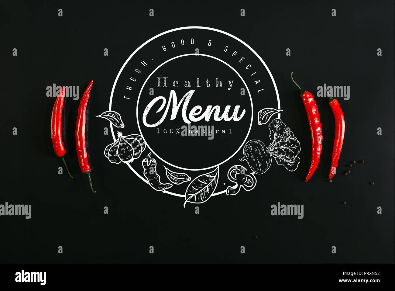 top view of red chili peppers and peppercorns on black background with ...
