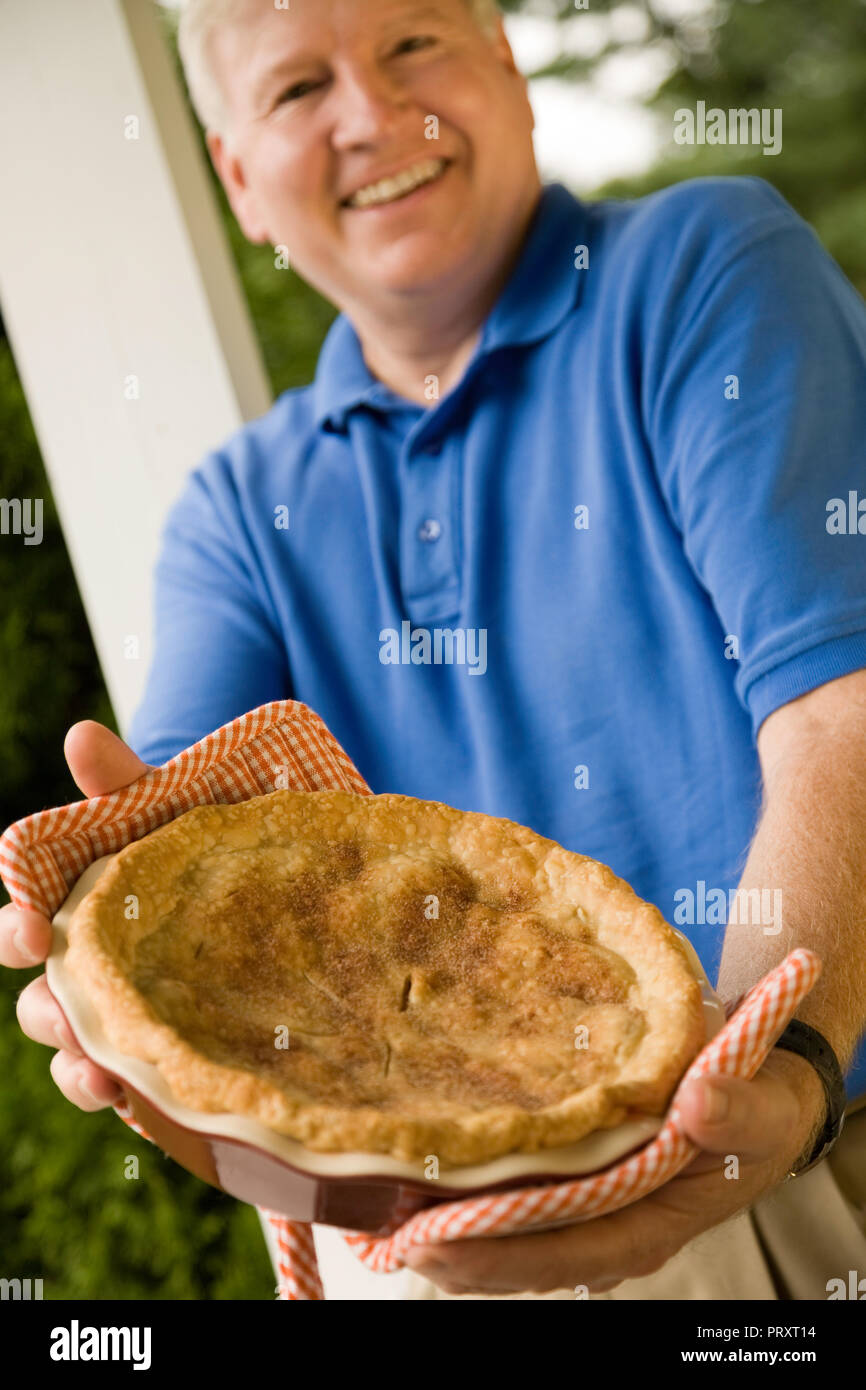 Senior man shows off his freshly baked pie, USA Stock Photo - Alamy