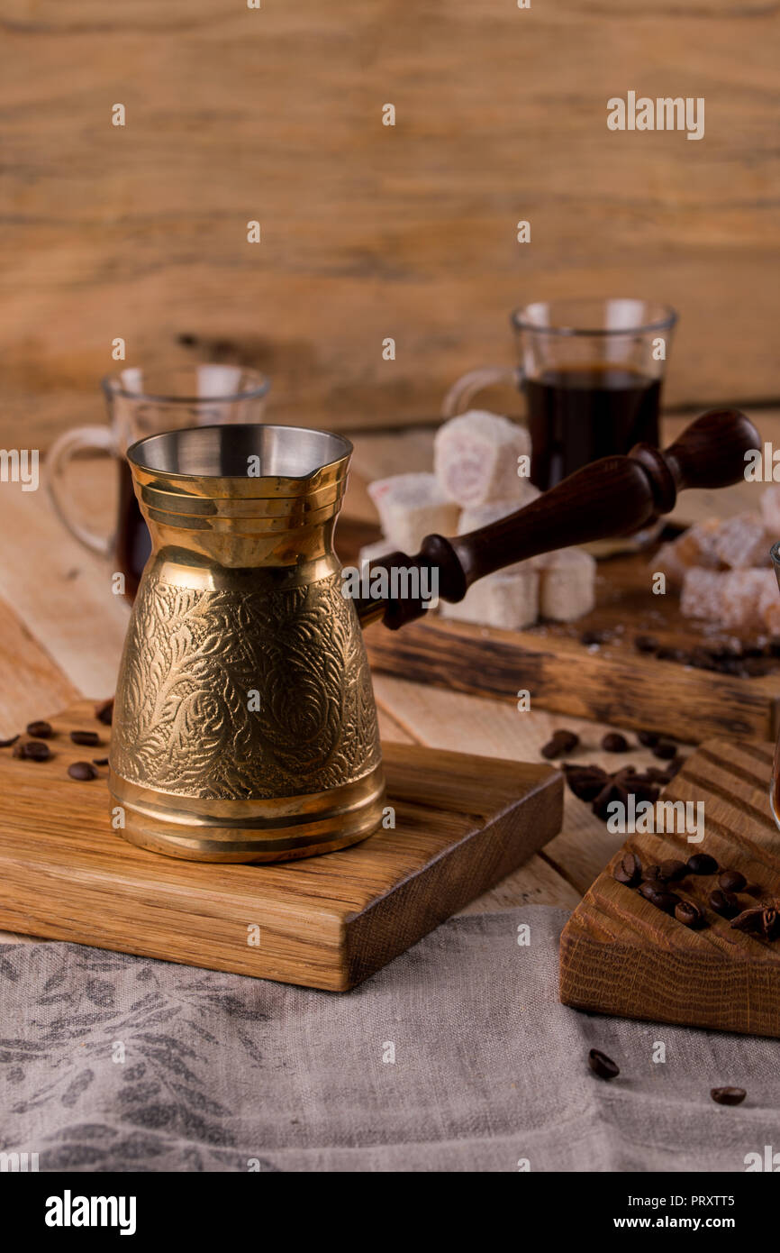 turkish coffee into traditional embossed metal turk. close-up shot of ...