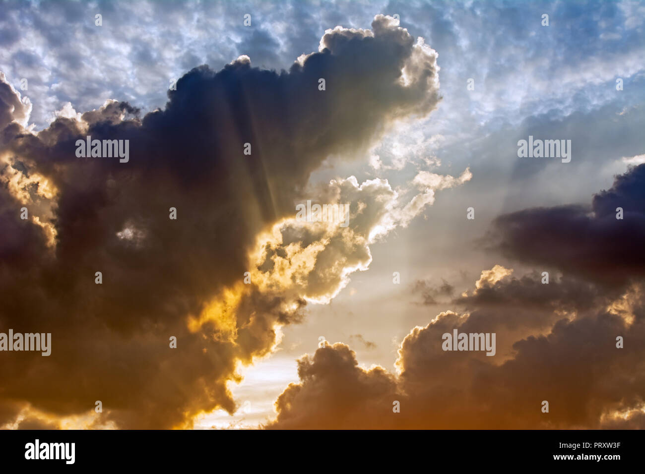 Dramatic sky with sunbeams at an approaching thunderstorm Stock Photo ...