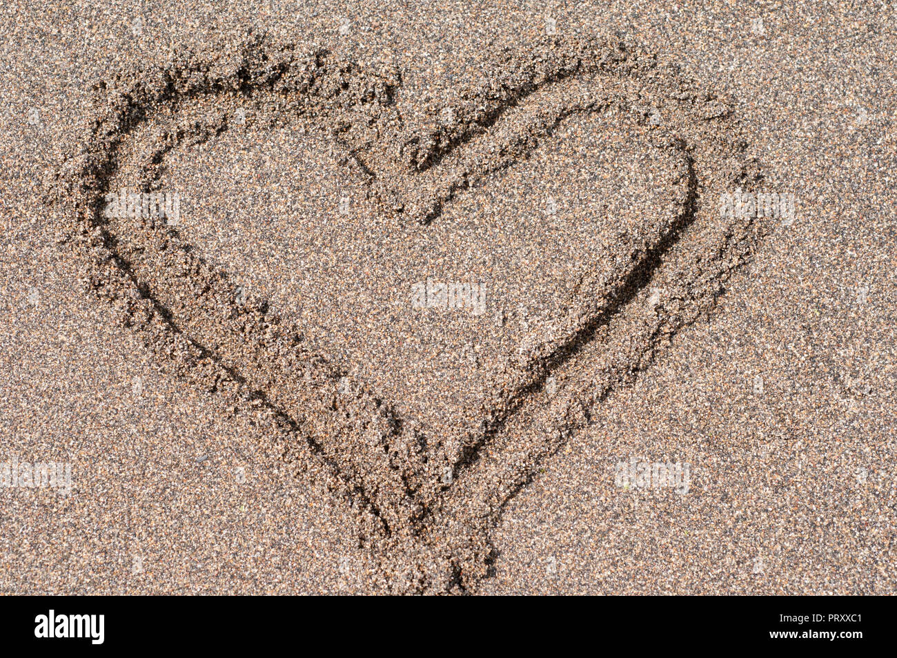 Heart drawn in sand Stock Photo - Alamy