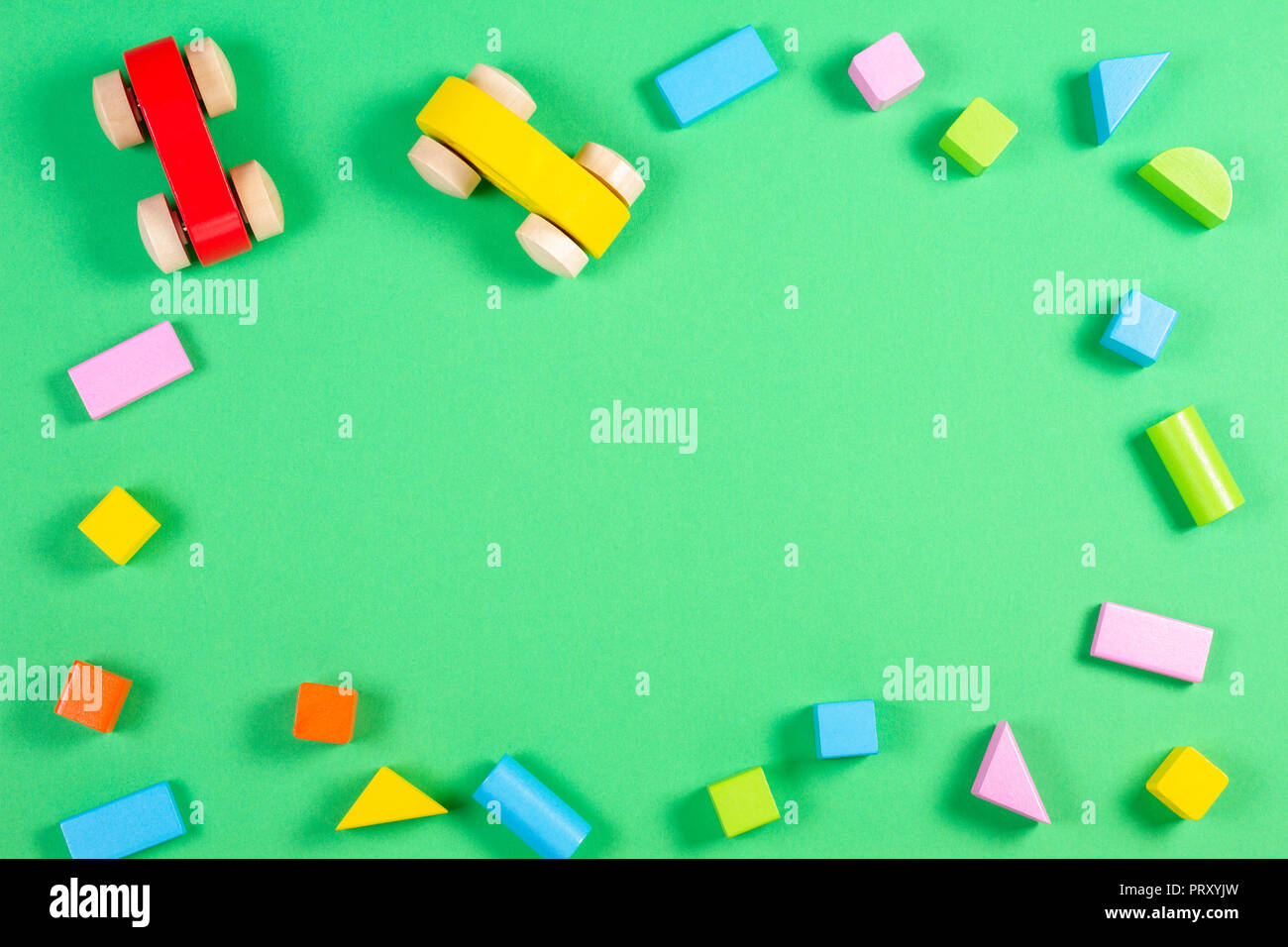 Colorful wooden toys and blocks on green color background Stock Photo ...